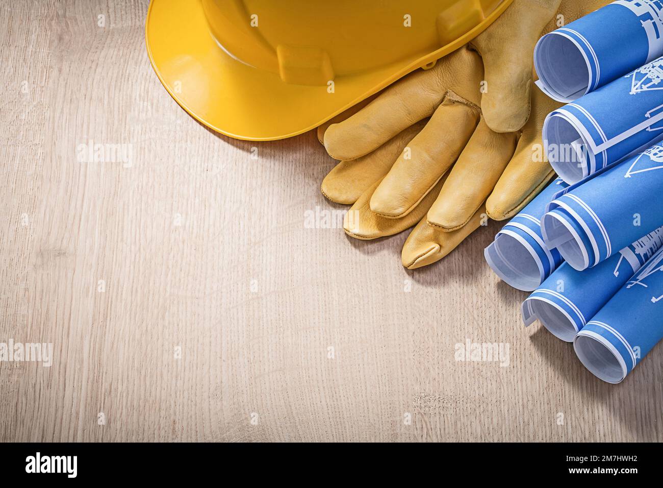 Blue engineering drawings building helmet leather safety gloves on ...
