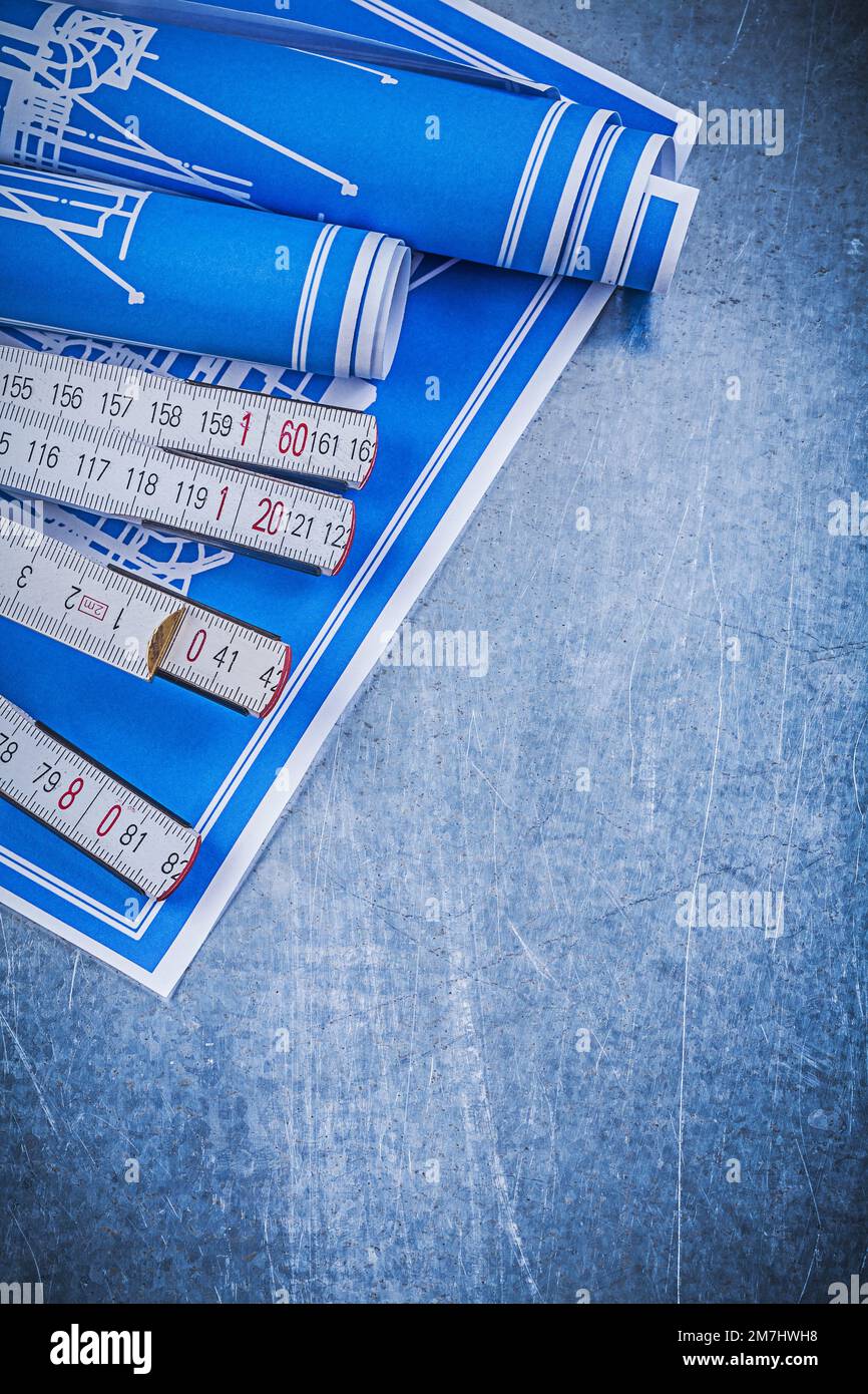 Blue construction drawings wooden meter on metallic background ...