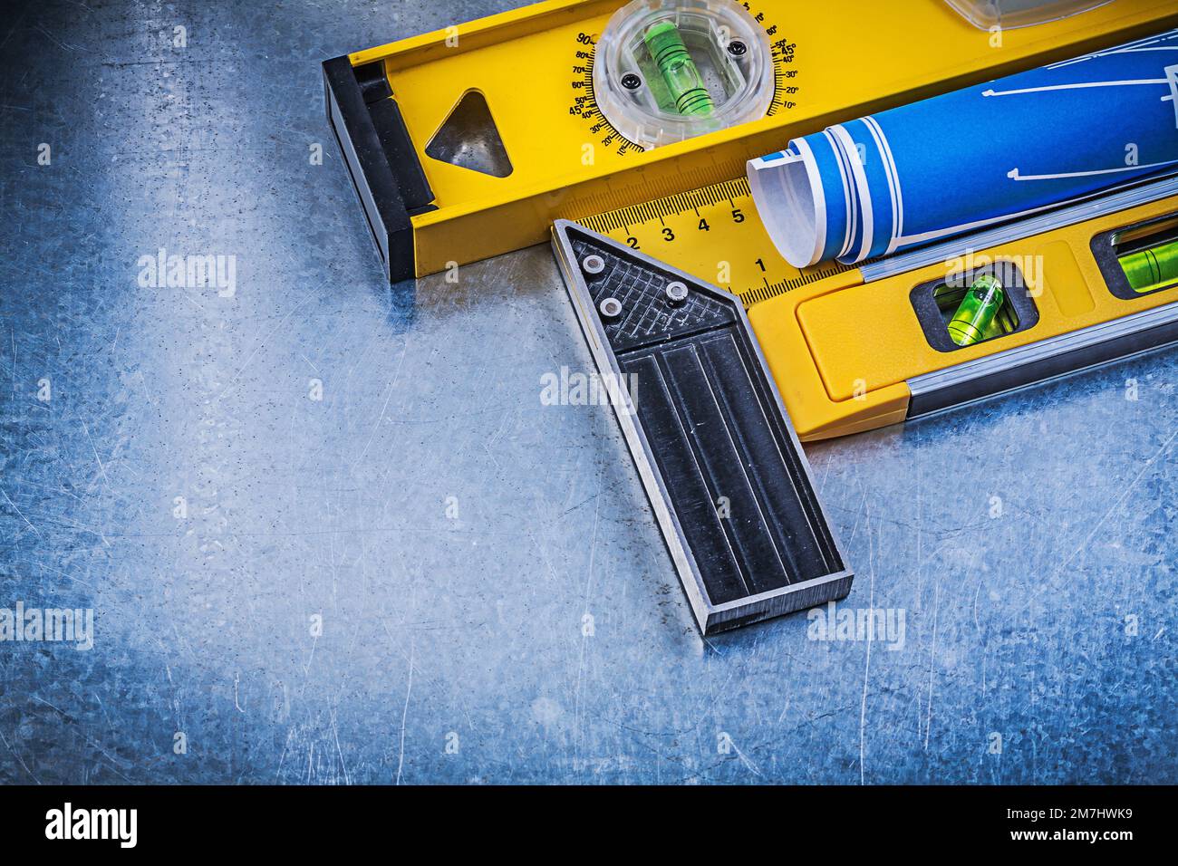 Blue engineering drawings construction levels try square on metallic ...