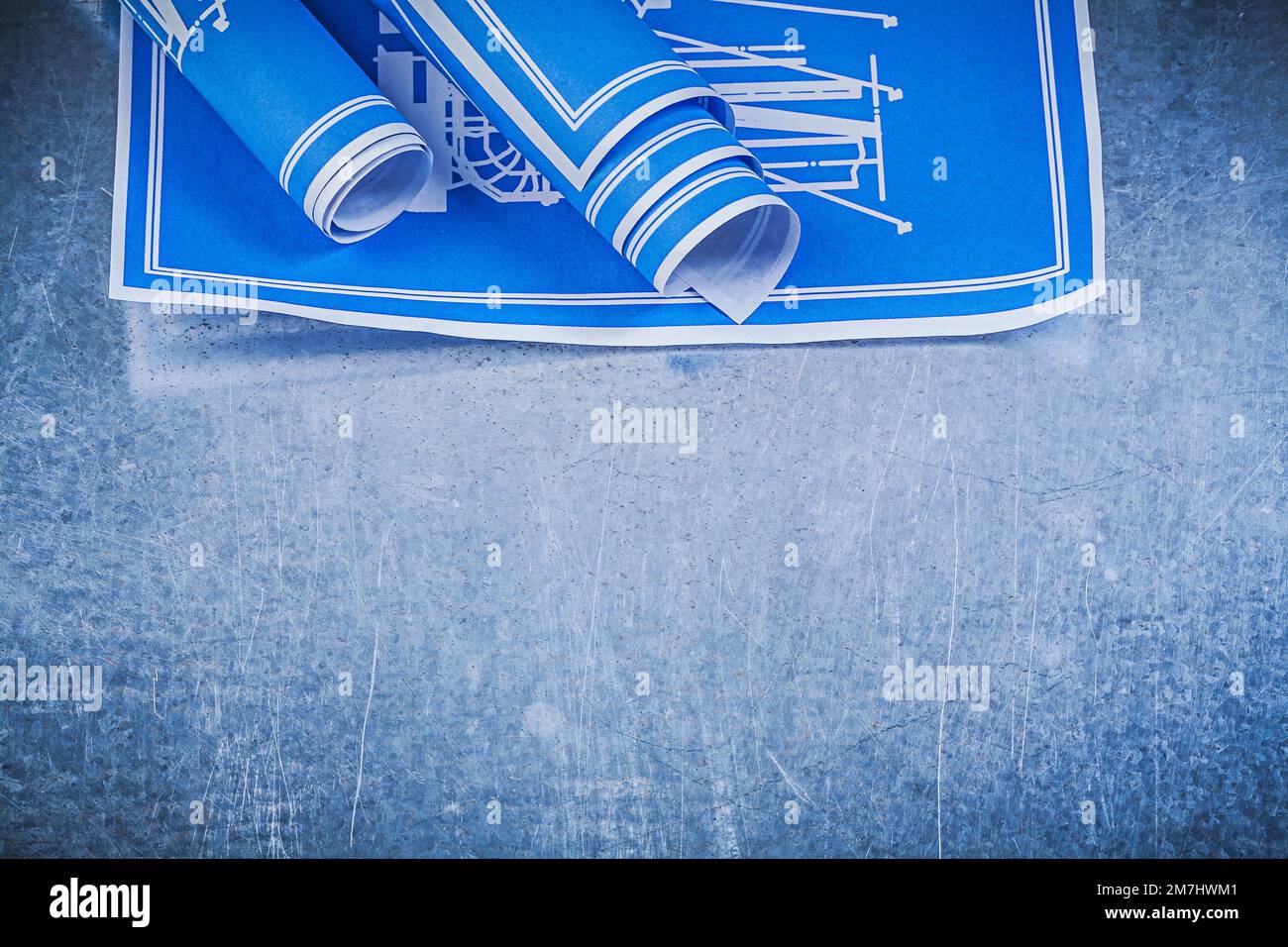 Blue engineering drawings on metallic background maintenance concept ...