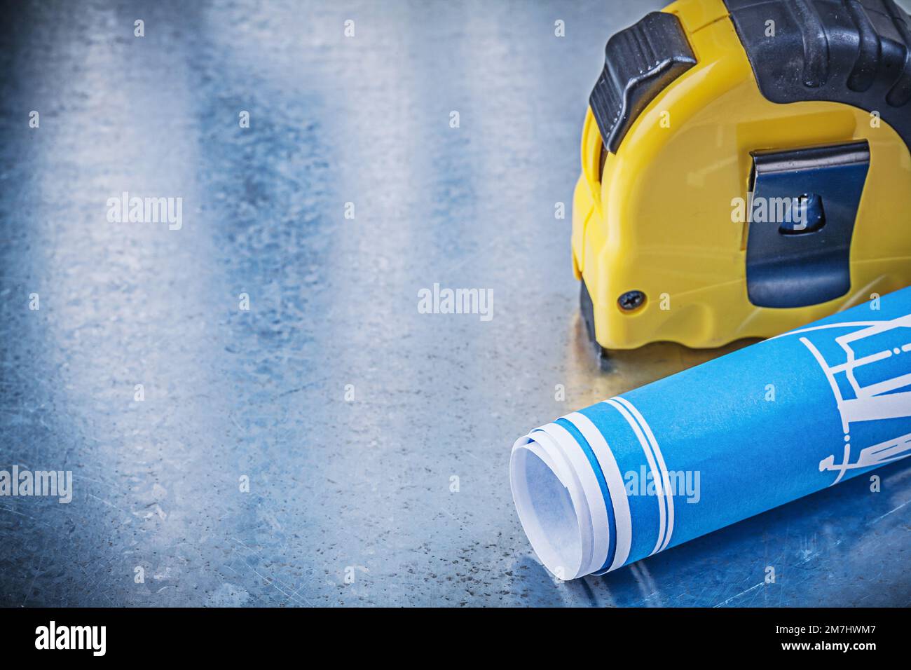 Blue engineering drawings tape measure on metallic background ...