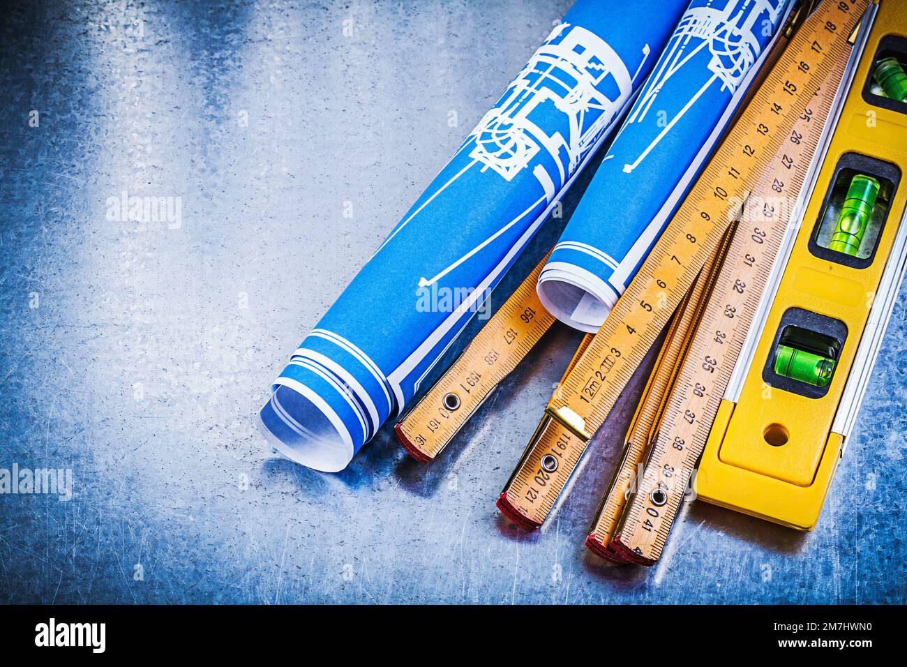 Blue engineering drawings wooden meter construction level on metallic ...