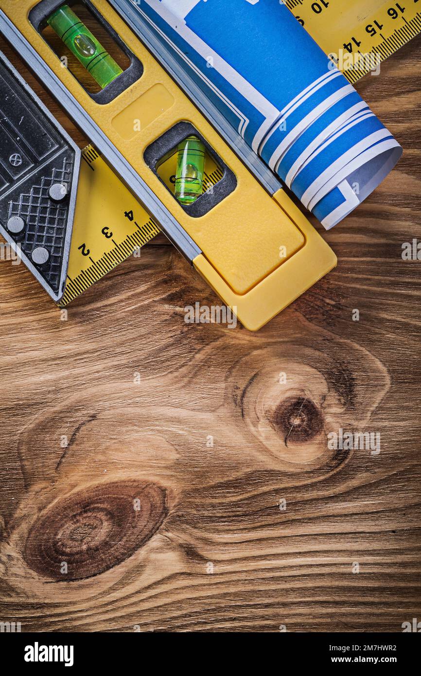 Blue rolled construction plan level square ruler on wood board Stock ...