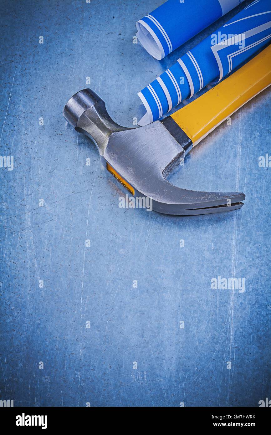 Blue rolled construction plans claw hammer on metallic background Stock ...