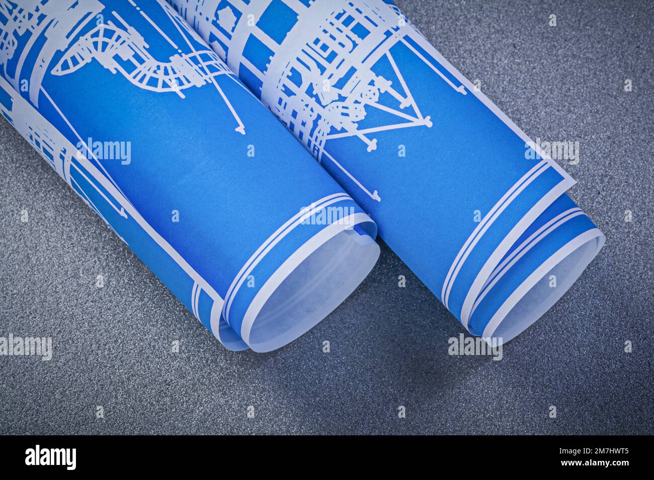 Blue rolled engineering drawings on grey background construction ...