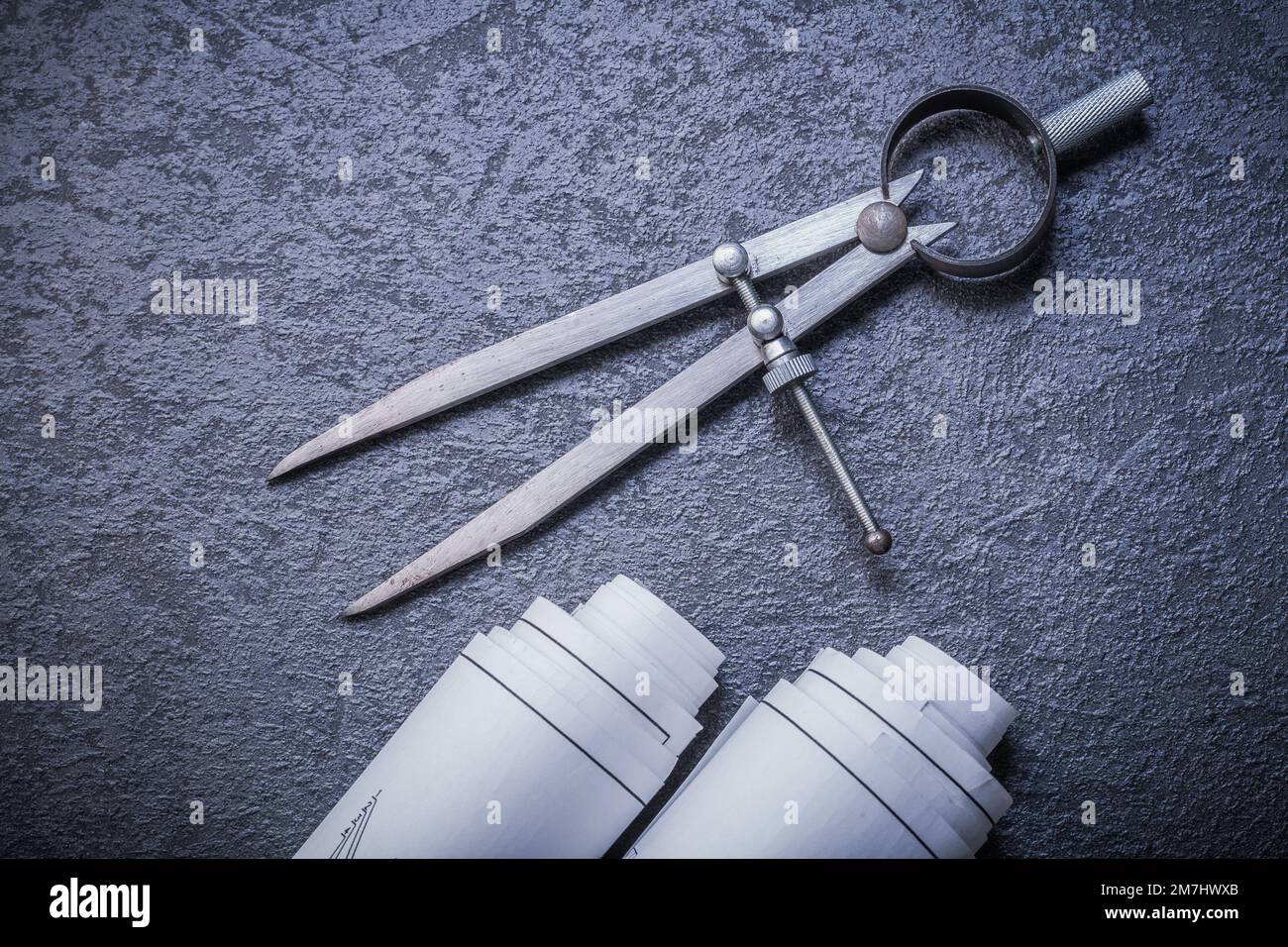 Blueprint rolls pair of compasses on black background maintenance ...