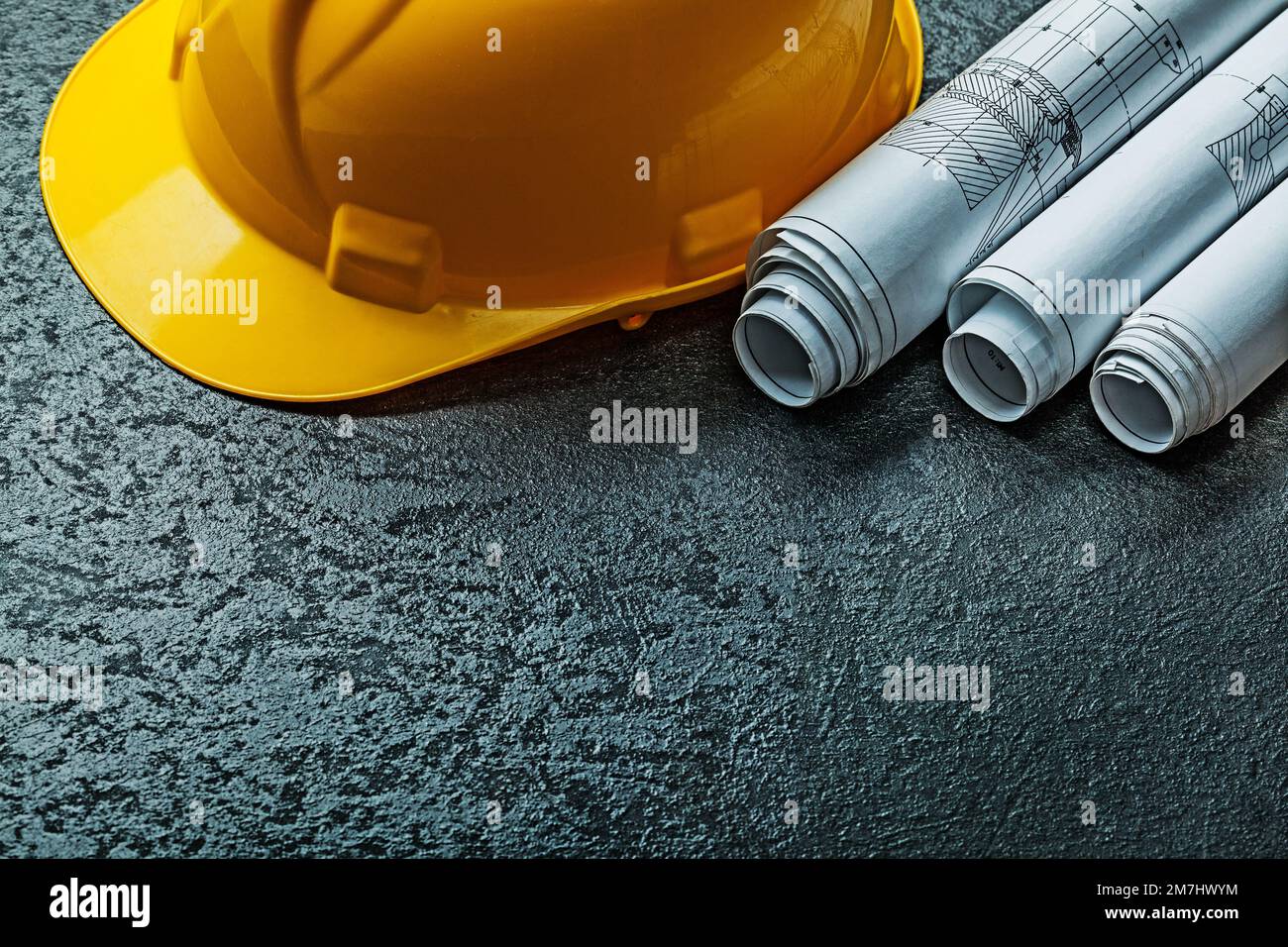 Yellow helmet rolled blueprints hi-res stock photography and images - Alamy