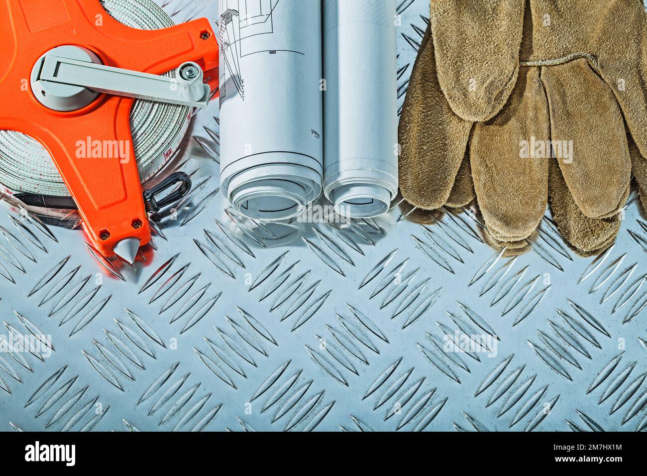 Blueprints safety gloves measuring tape on fluted metal sheet Stock ...