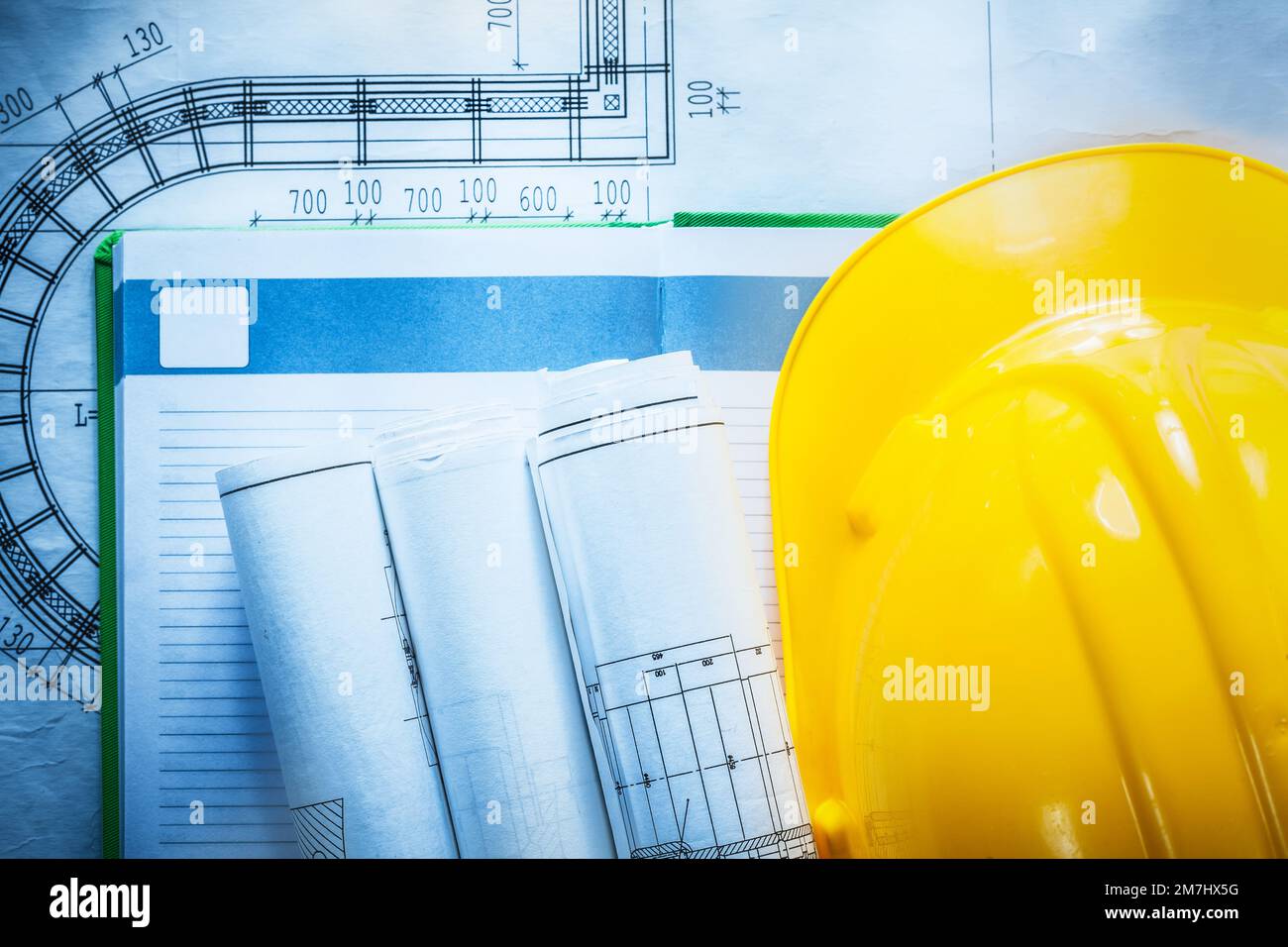 Building helmet construction plans notepad on blueprint Stock Photo - Alamy
