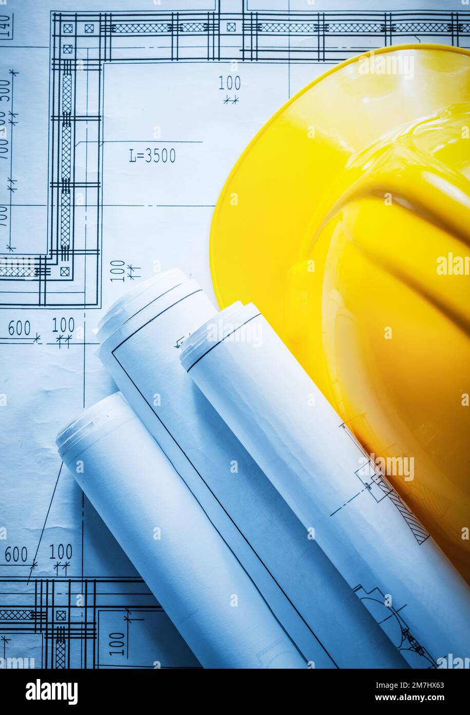 Building helmet rolled construction drawings on blueprint Stock Photo ...