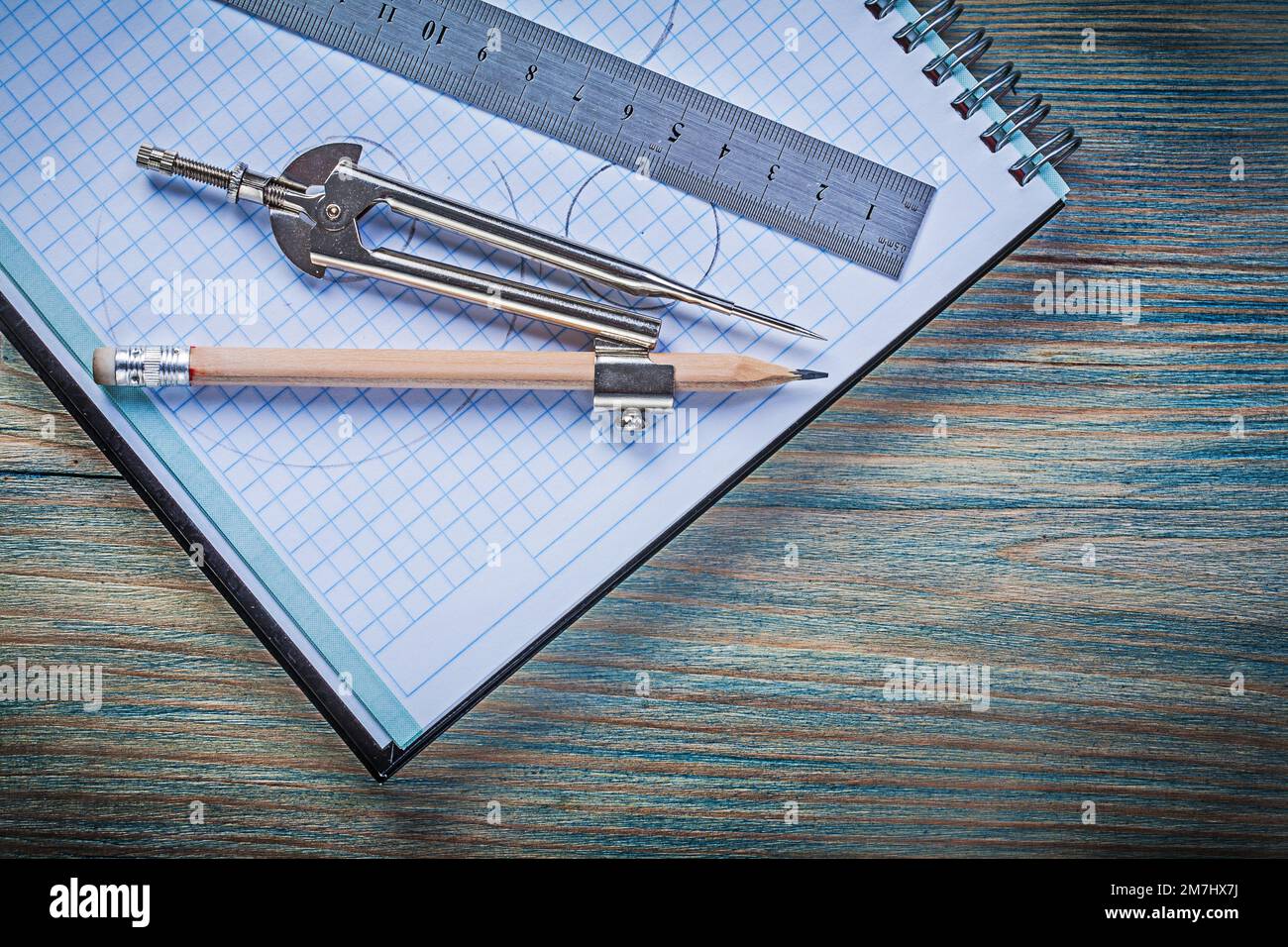 Checked notepad metal ruler drawing compass pencil on vintage wooden ...