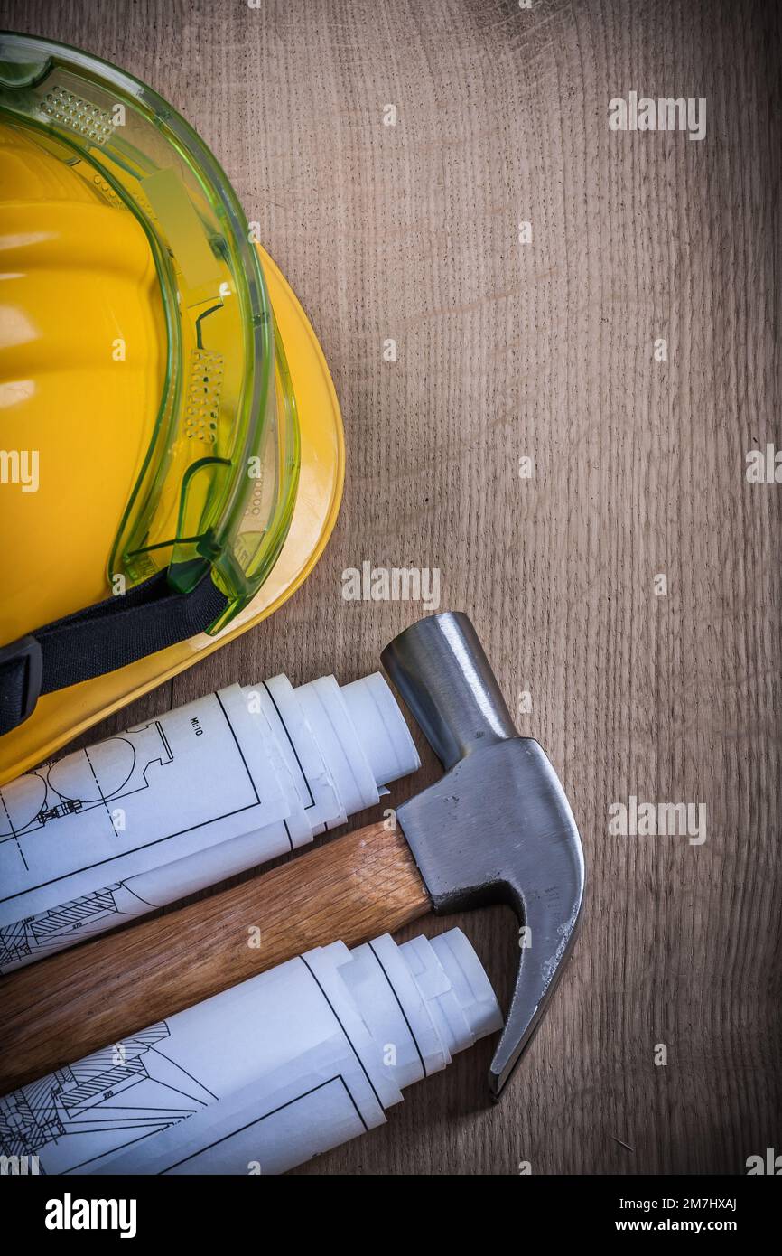 Claw hammer protective spectacles rolled blueprints and building helmet ...