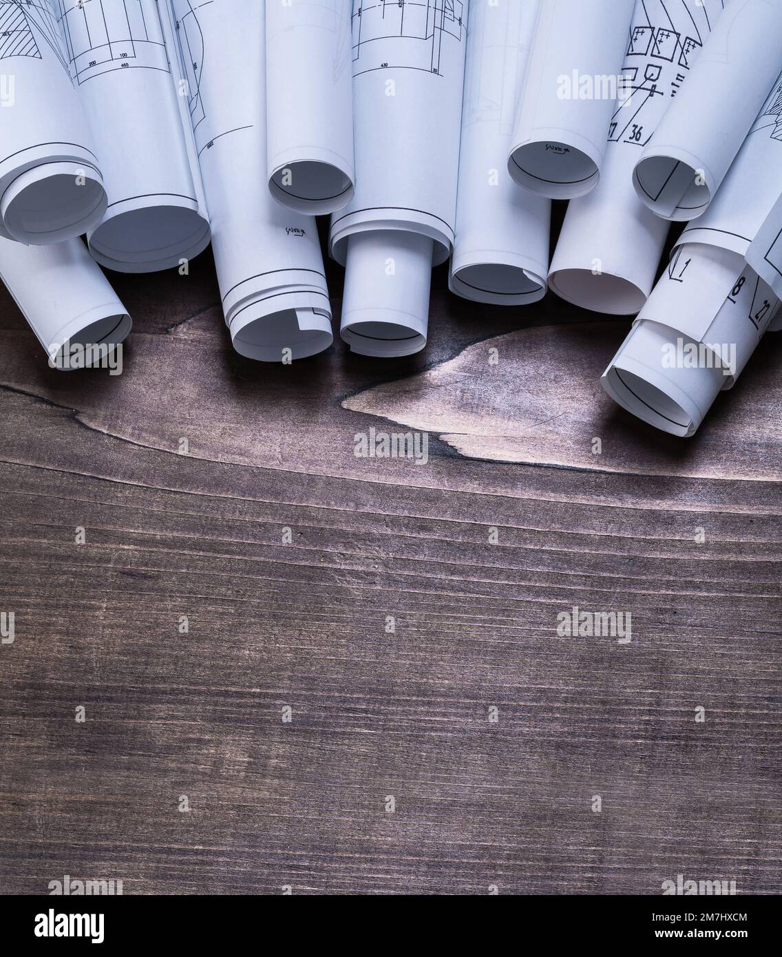 Collection of blueprint rolls on pine wooden vintage board construction ...