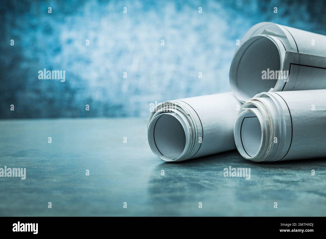 close up view on roled blueprint metalic background Stock Photo - Alamy
