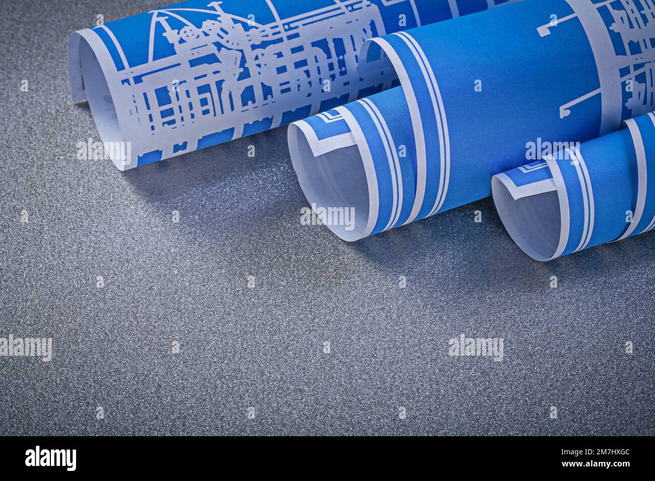 Collection of blue blueprints on grey surface construction concept ...