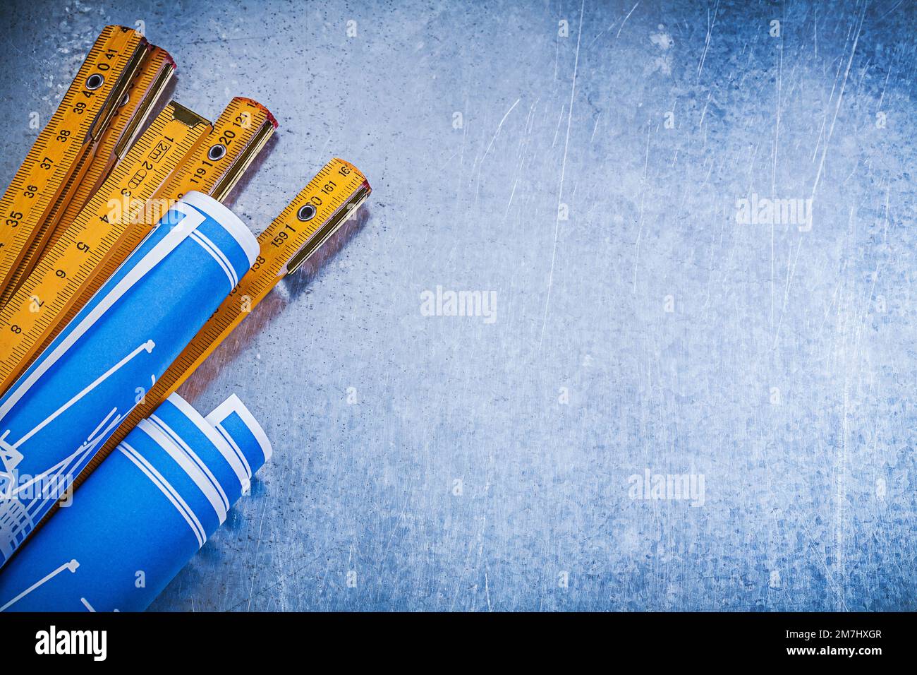 Collection of blue construction drawings wooden meter on metallic ...