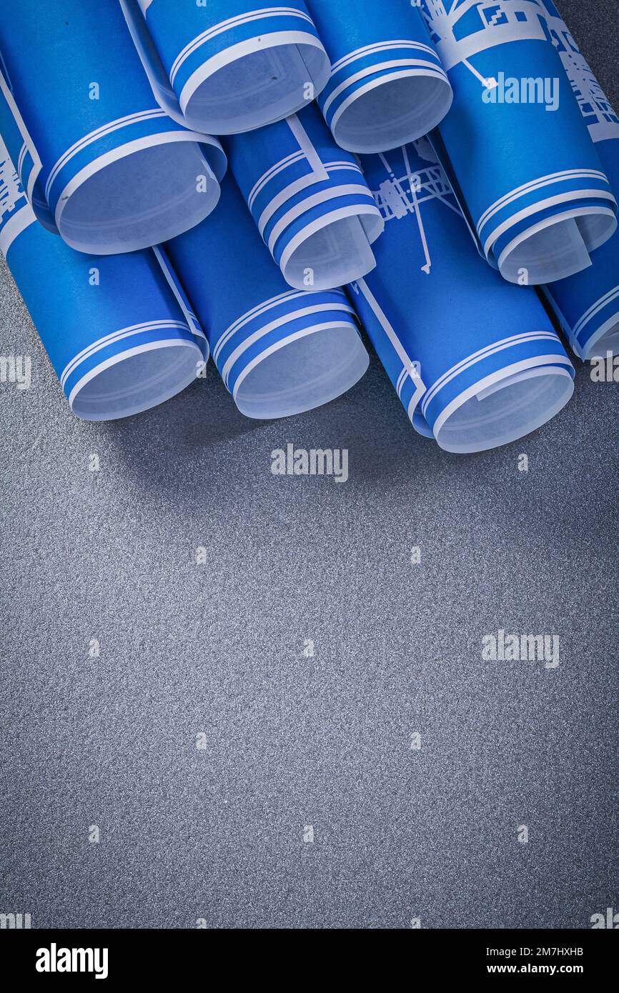 Composition of blue rolled construction plans on grey background ...