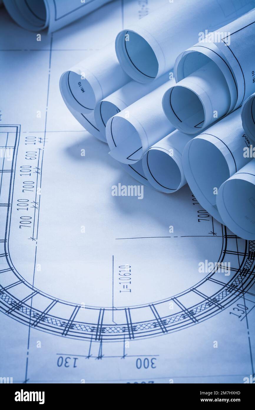 Composition of blueprint rolls construction concept Stock Photo - Alamy