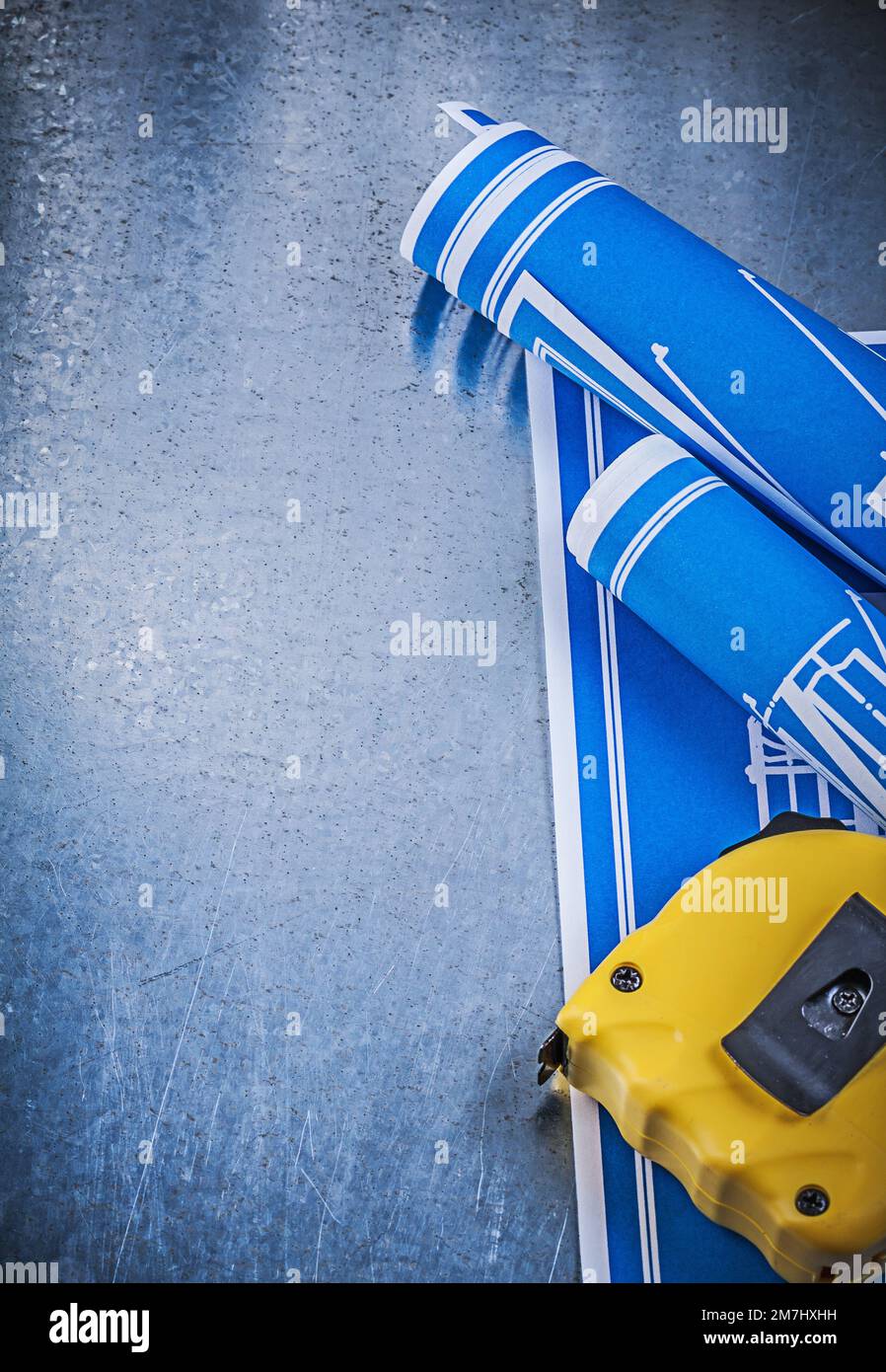 Composition of blue construction plans measuring line on metallic ...