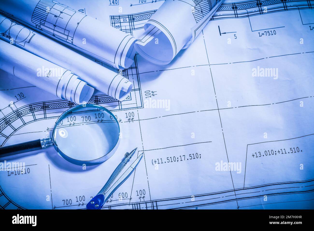 compass magnifer and blueprints close up Stock Photo - Alamy