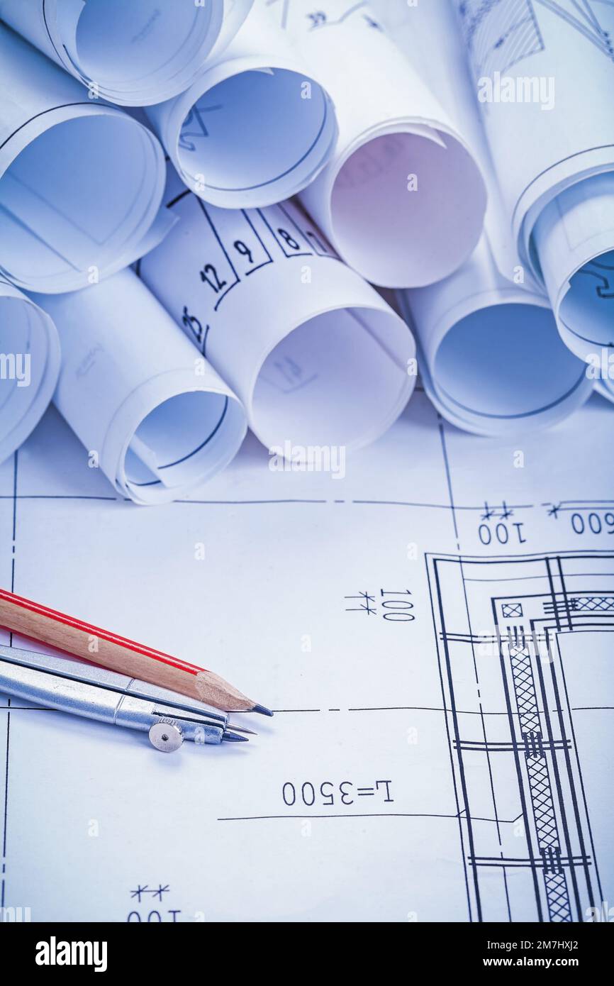 compass pencil and big stack of white rolled up blueprints Stock Photo ...