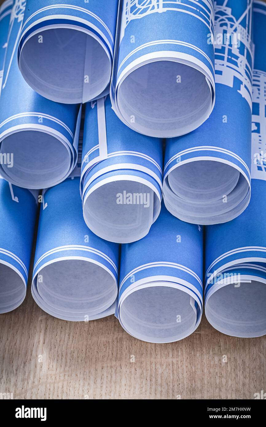 Composition of rolled engineering drawings on wooden board construction ...