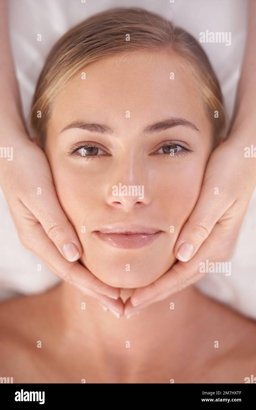 This is where great skin starts. An attractive young woman having a massage at the spa Stock ...