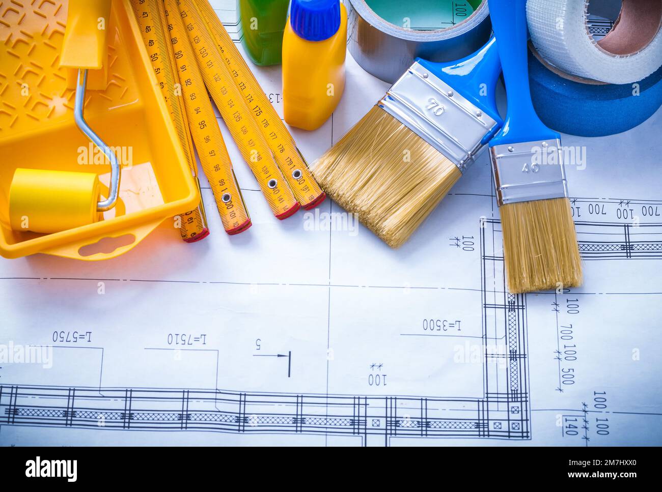 Construction drawing with paint tools duct tape and wooden meter ...