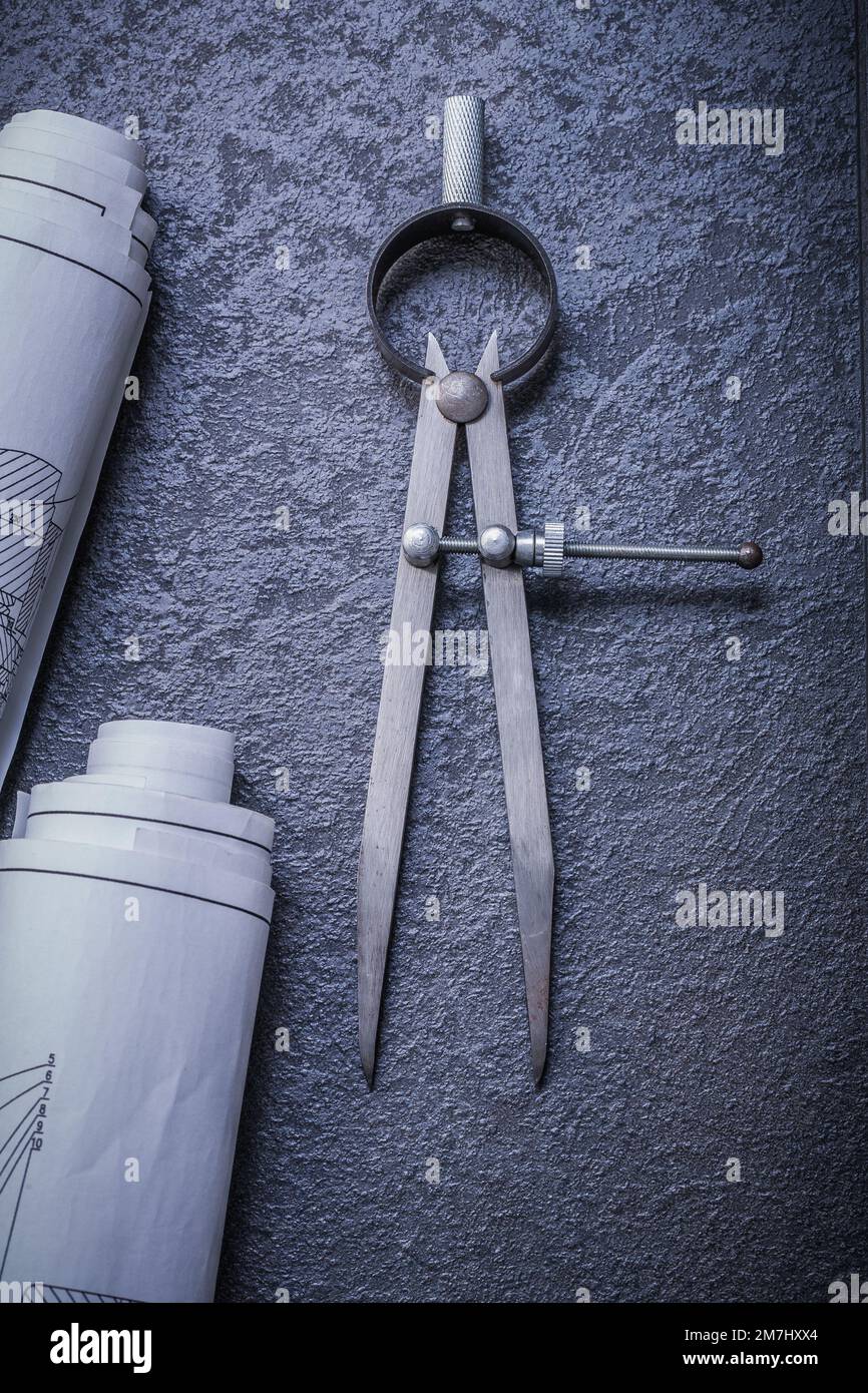 Construction drawings pair of compasses on black surface maintenance ...