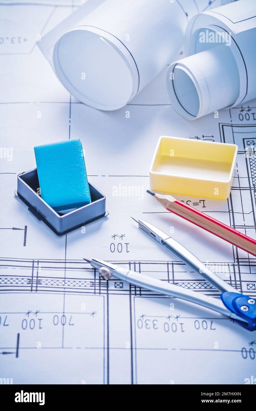 construction concept composition rolls of blueprints eraser compass ...