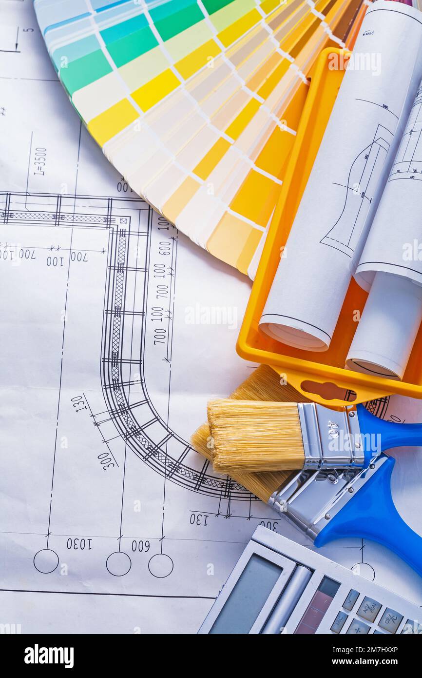 composition paintbrushes calculator rolled blueprints in yeelow pain ...