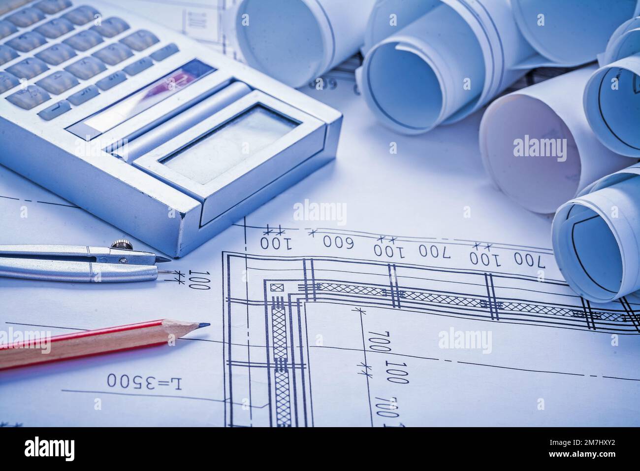 composition rolled blueprints calculator pencil compass Stock Photo - Alamy