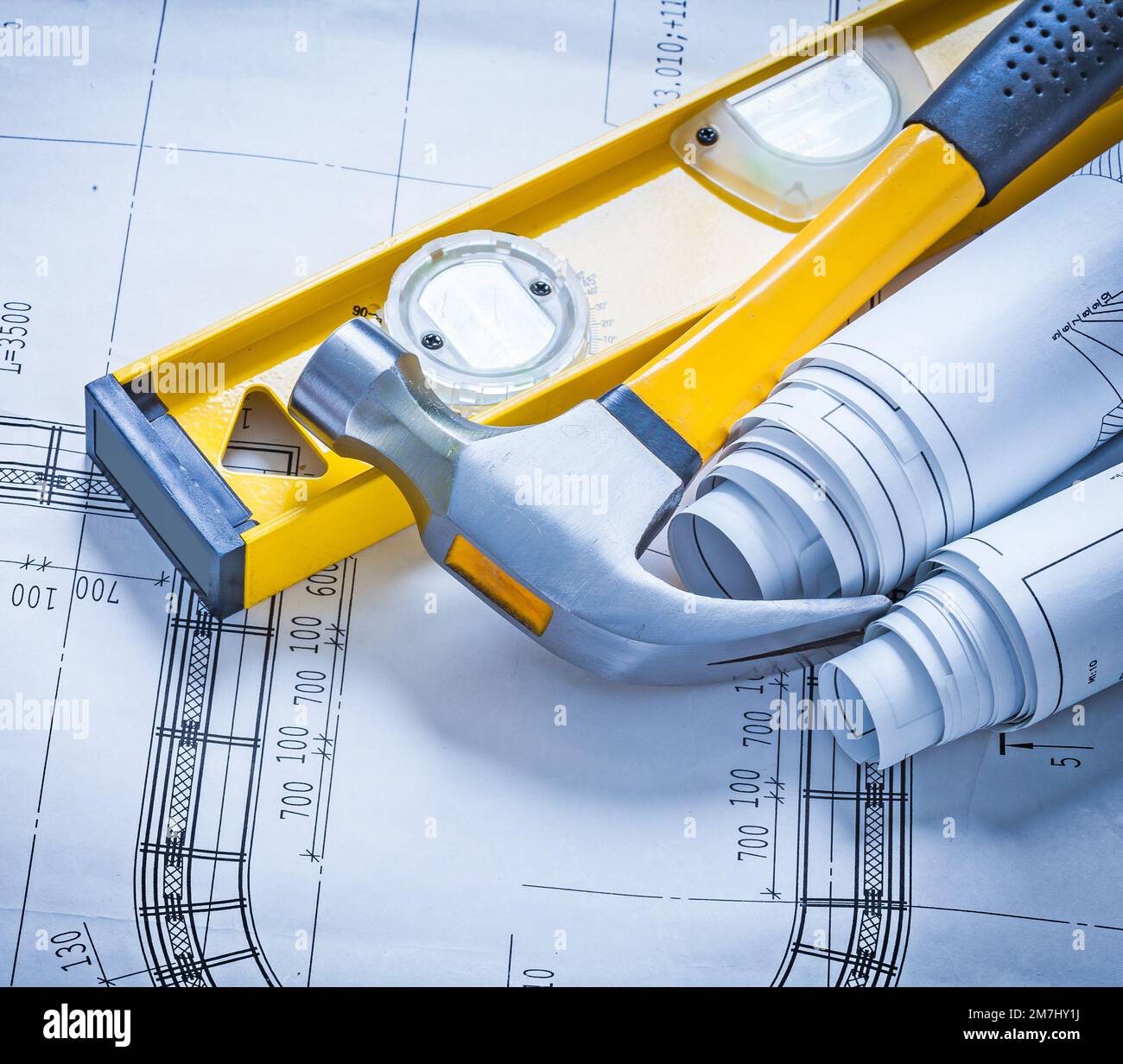 Construction level claw hammer and rolls of blueprints maintenance ...