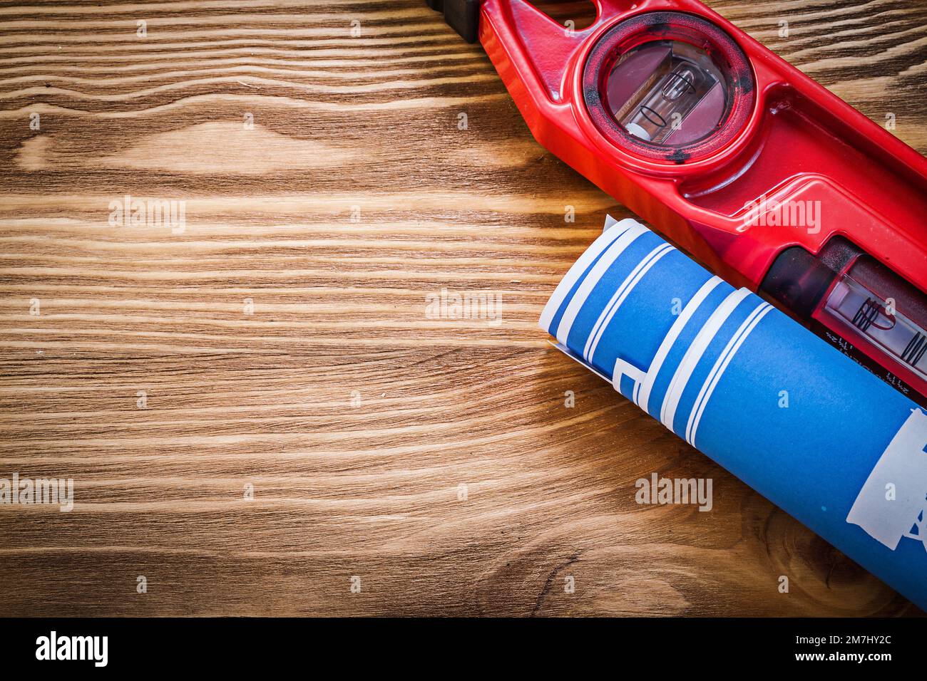 Construction level blue blueprint on vintage wood board Stock Photo - Alamy