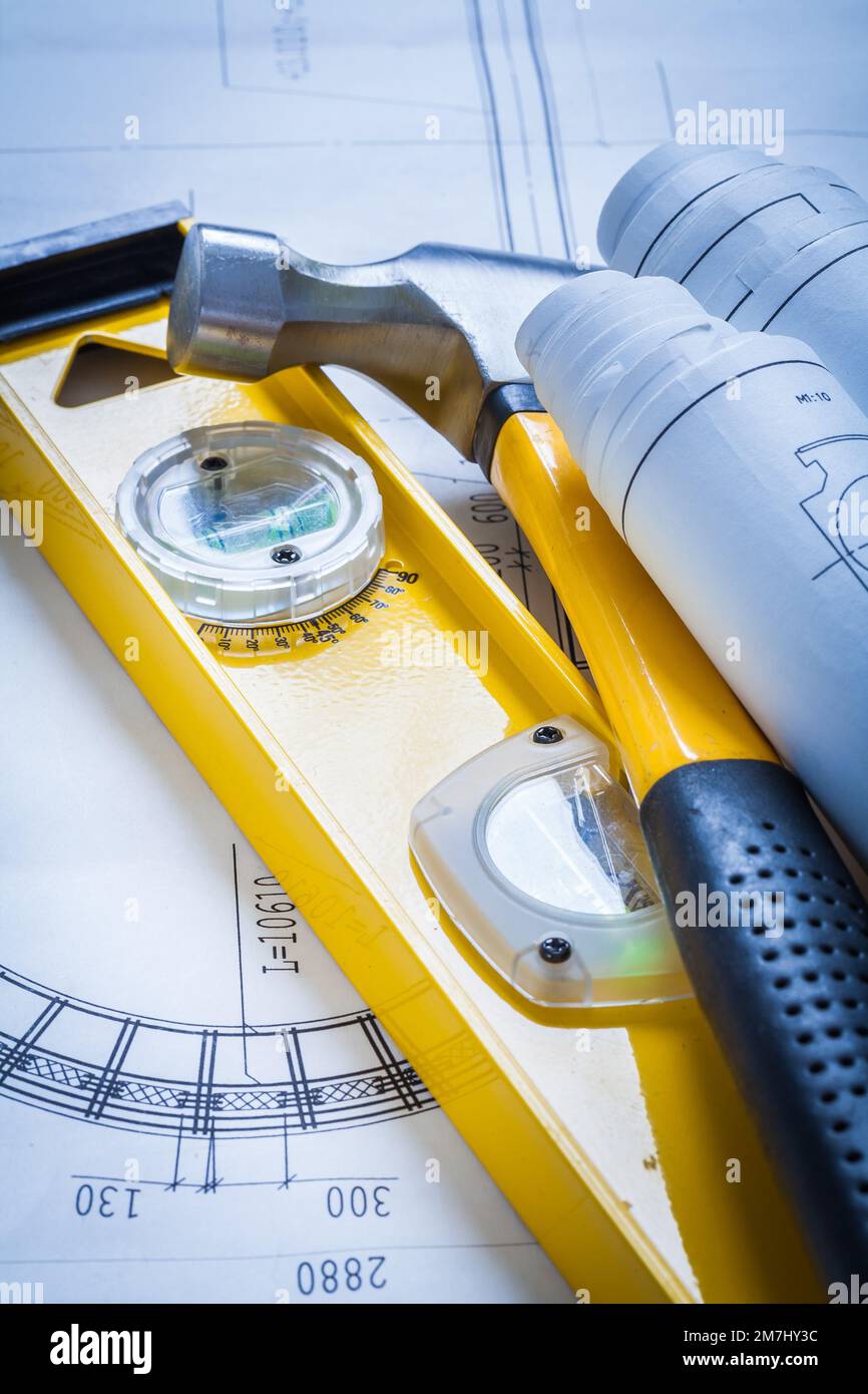 Construction level rolled up building sketches and claw hammer ...
