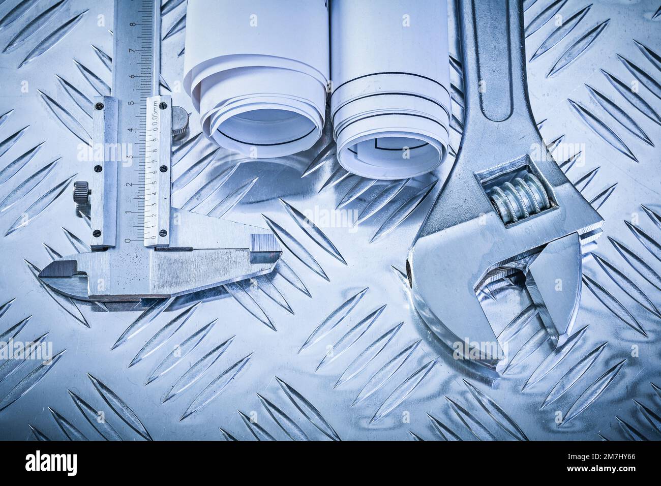 Construction plans vernier caliper adjustable wrench on grooved metal ...