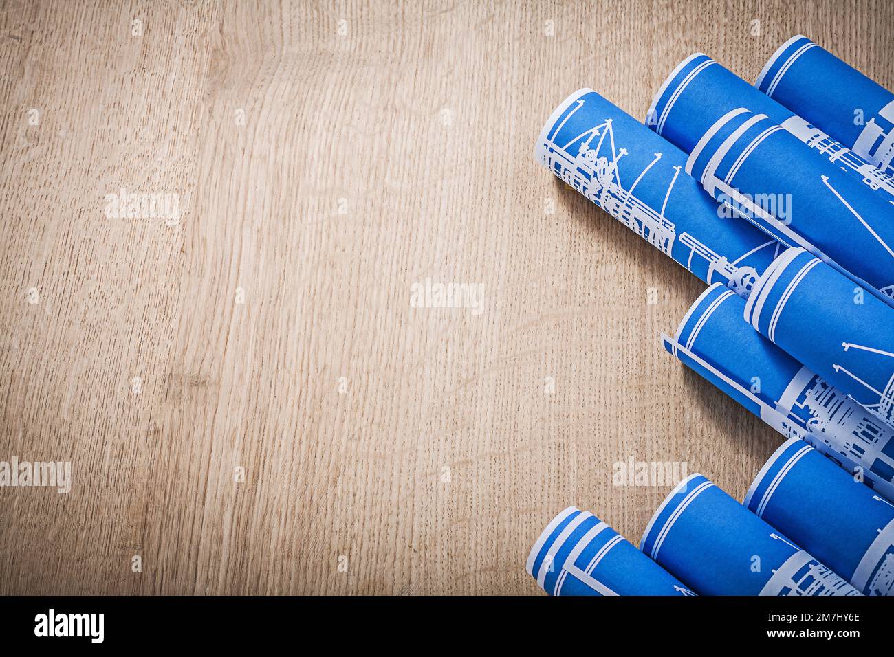 Copy space of blue rolled engineering drawings on wooden board ...
