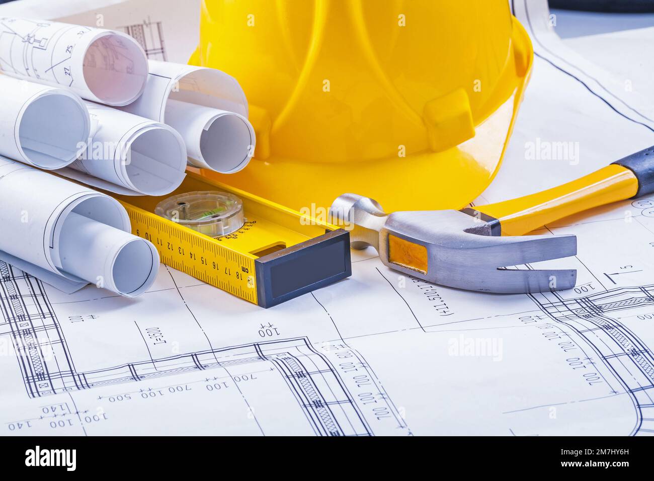 construction tools rolled blueprints level claw hammer helmet Stock ...