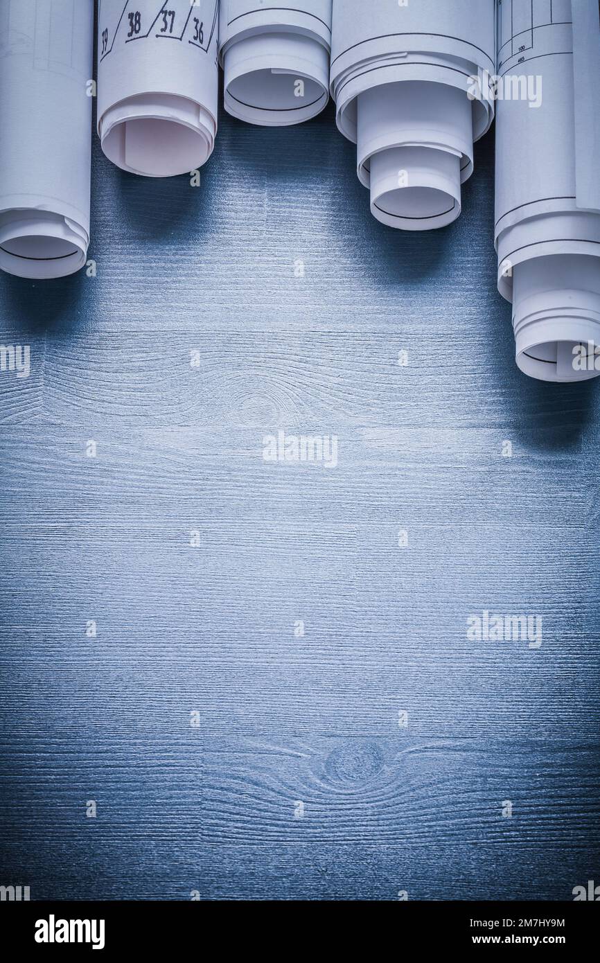 copyspace image five blueprints rolled up on blue board Stock Photo - Alamy