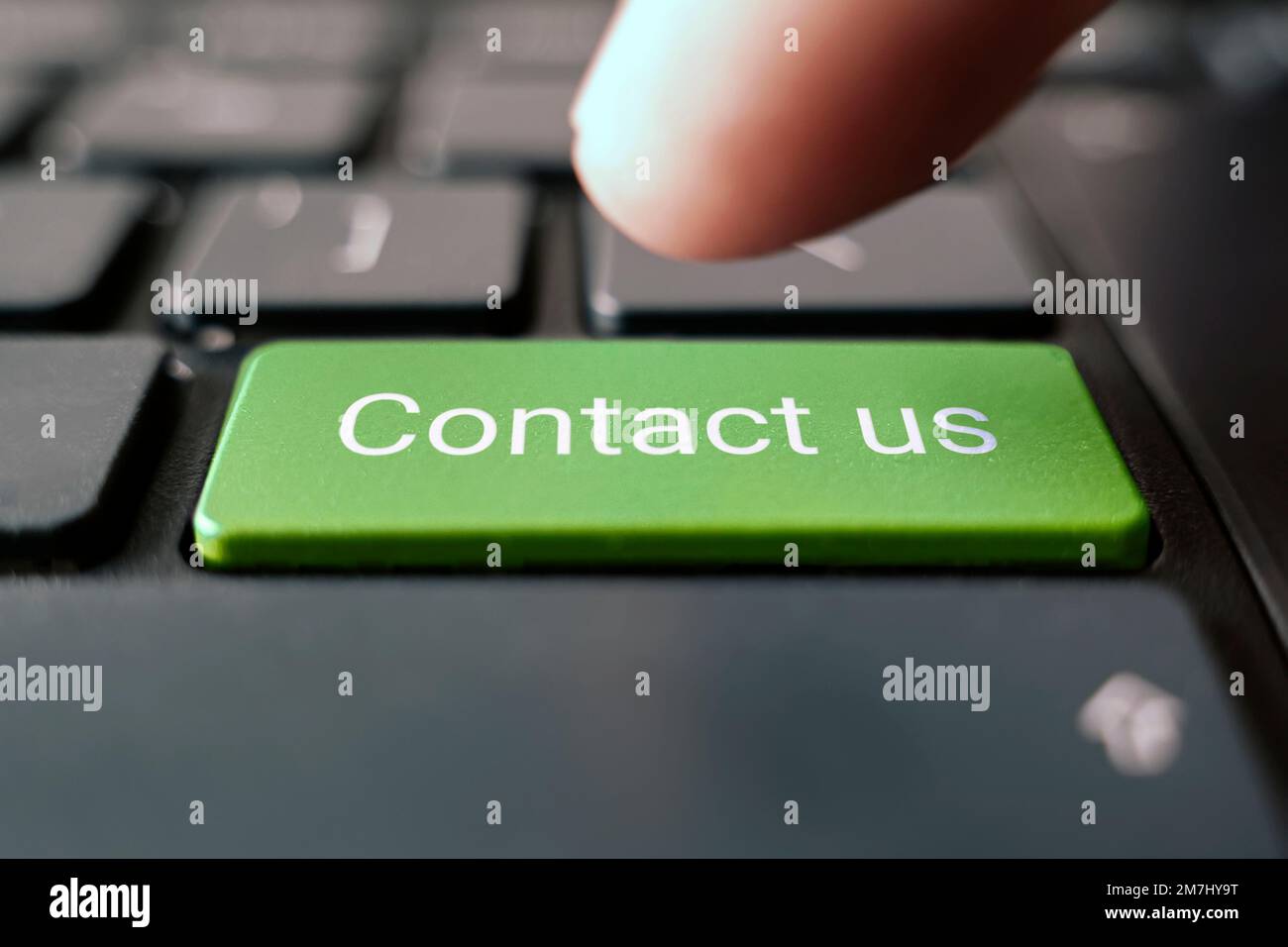 Big green contact us keyboard button. contact inscriptions on the ...