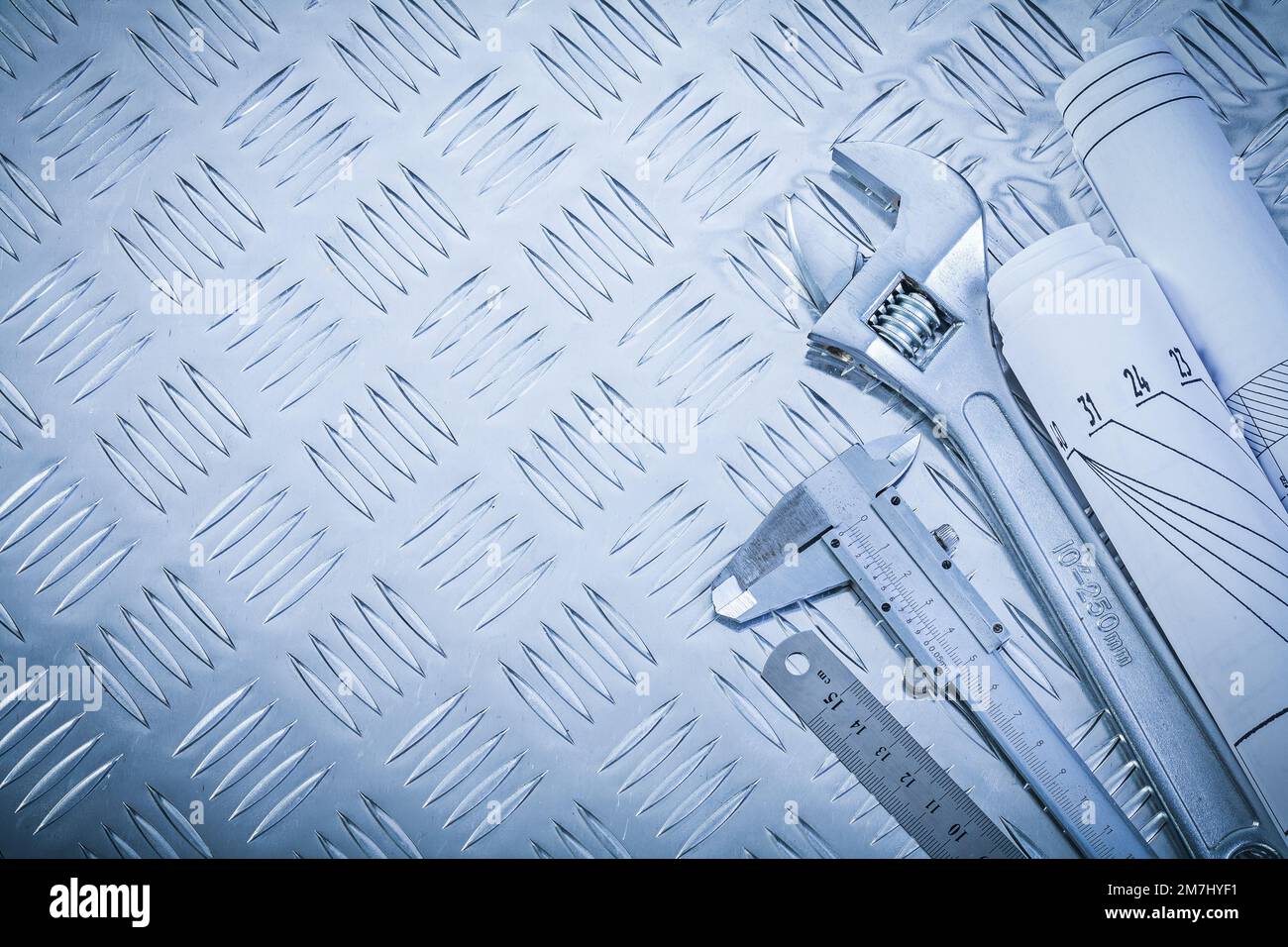 Engineering drawings vernier caliper monkey spanner on channeled metal ...