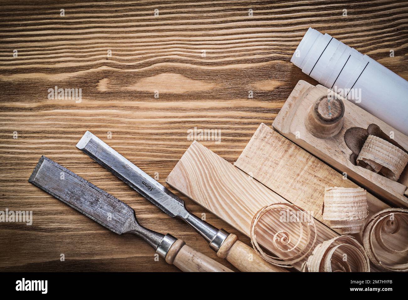 Engineering drawing planer chisels wooden bricks shavings on wood board ...