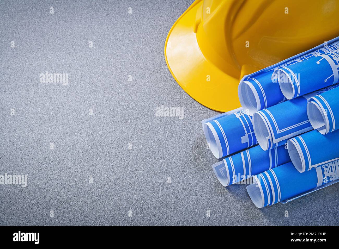 Hard hat blue engineering drawings on grey background construction ...