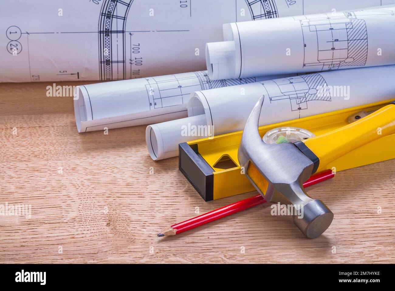 hammer pencil level blueprints on wooden board Stock Photo - Alamy