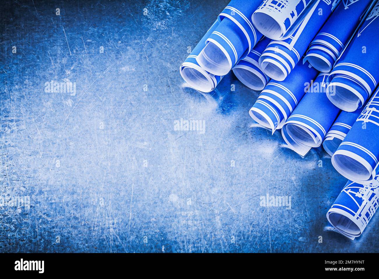 Heap of blue engineering drawings on metallic background construction ...