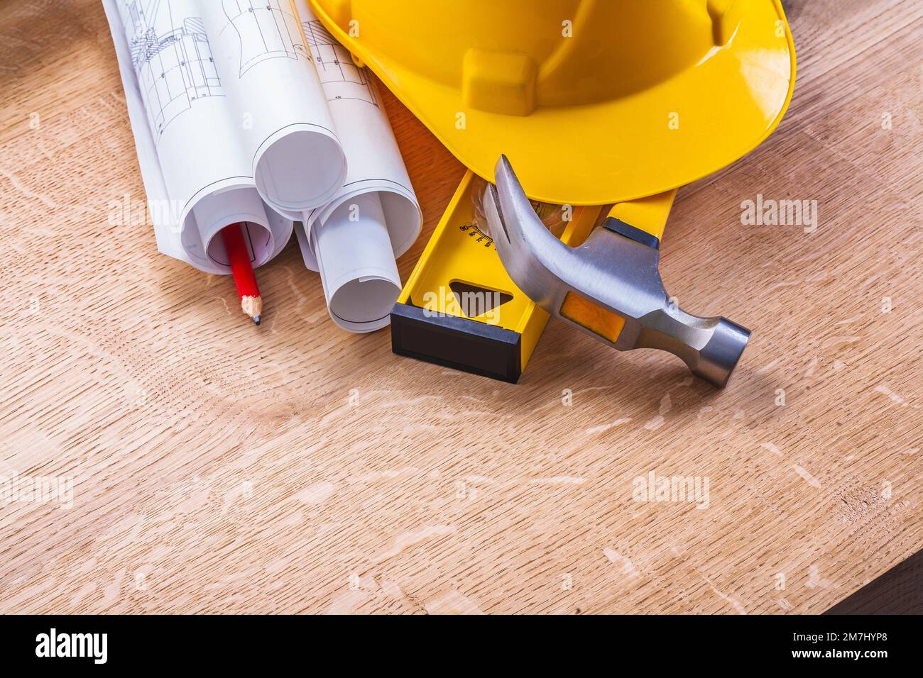 hardhat level hammer blueprints pencil on wooden boards Stock Photo - Alamy