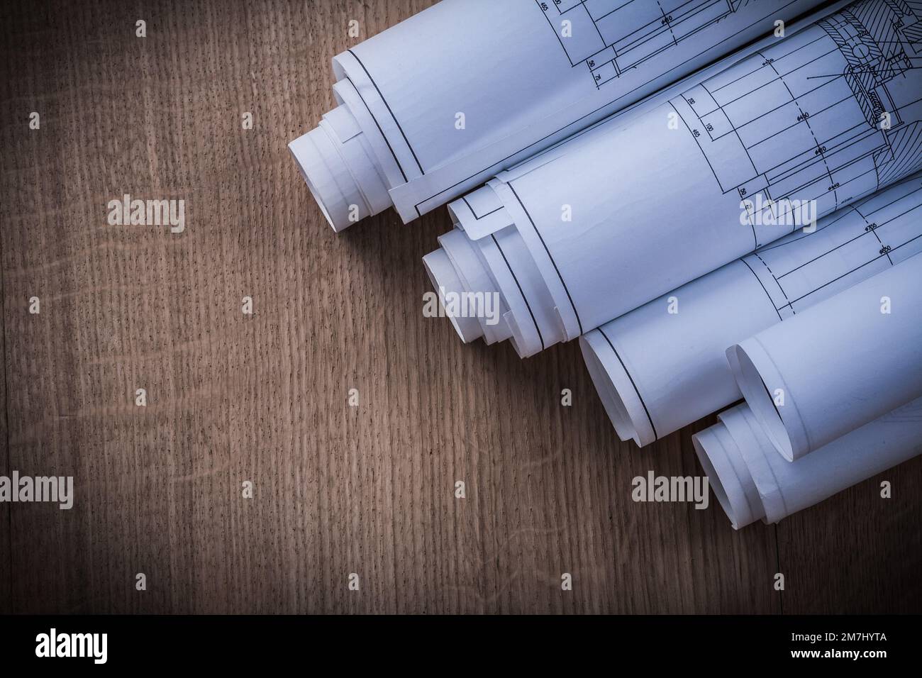 Heap of rolled blueprints on wood board construction concept Stock ...