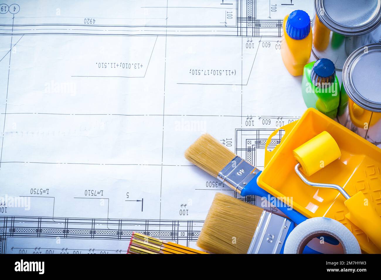 Household tape wooden meter and paint brush cans bottles tray roller on ...