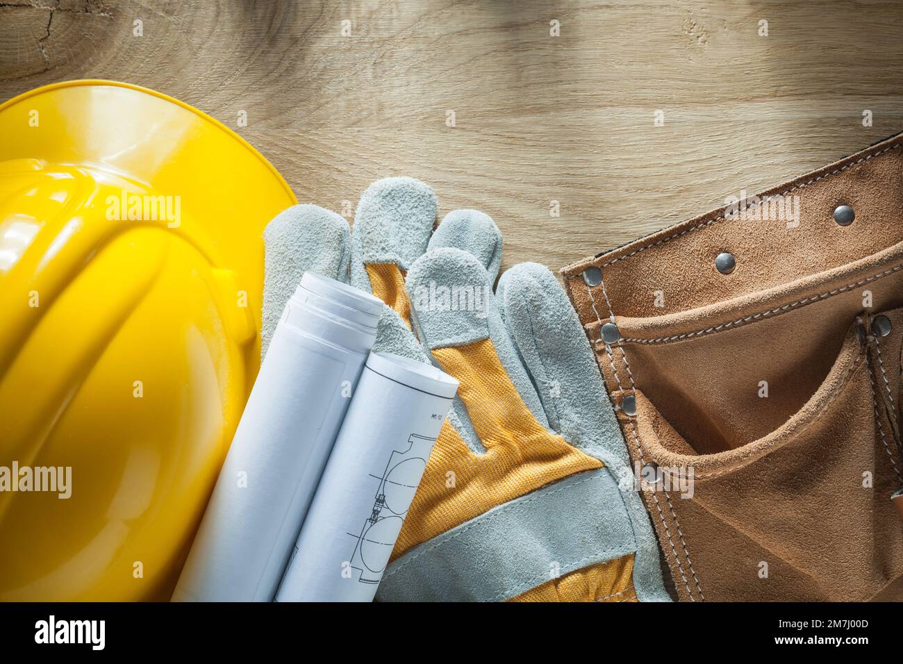 Leather tool belt blueprints protective gloves hard hat Stock Photo - Alamy