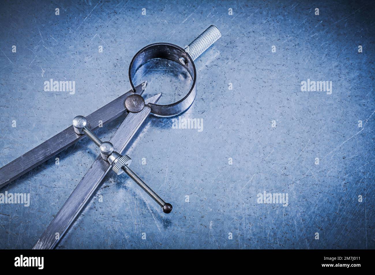 Metal construction drawing compass on metallic background Stock Photo ...